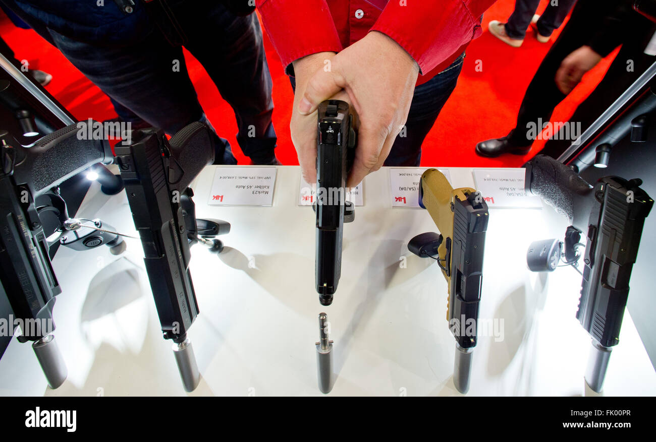 Nuremberg, Germany. 4th Mar, 2016. A visitor holding a gun of the ...