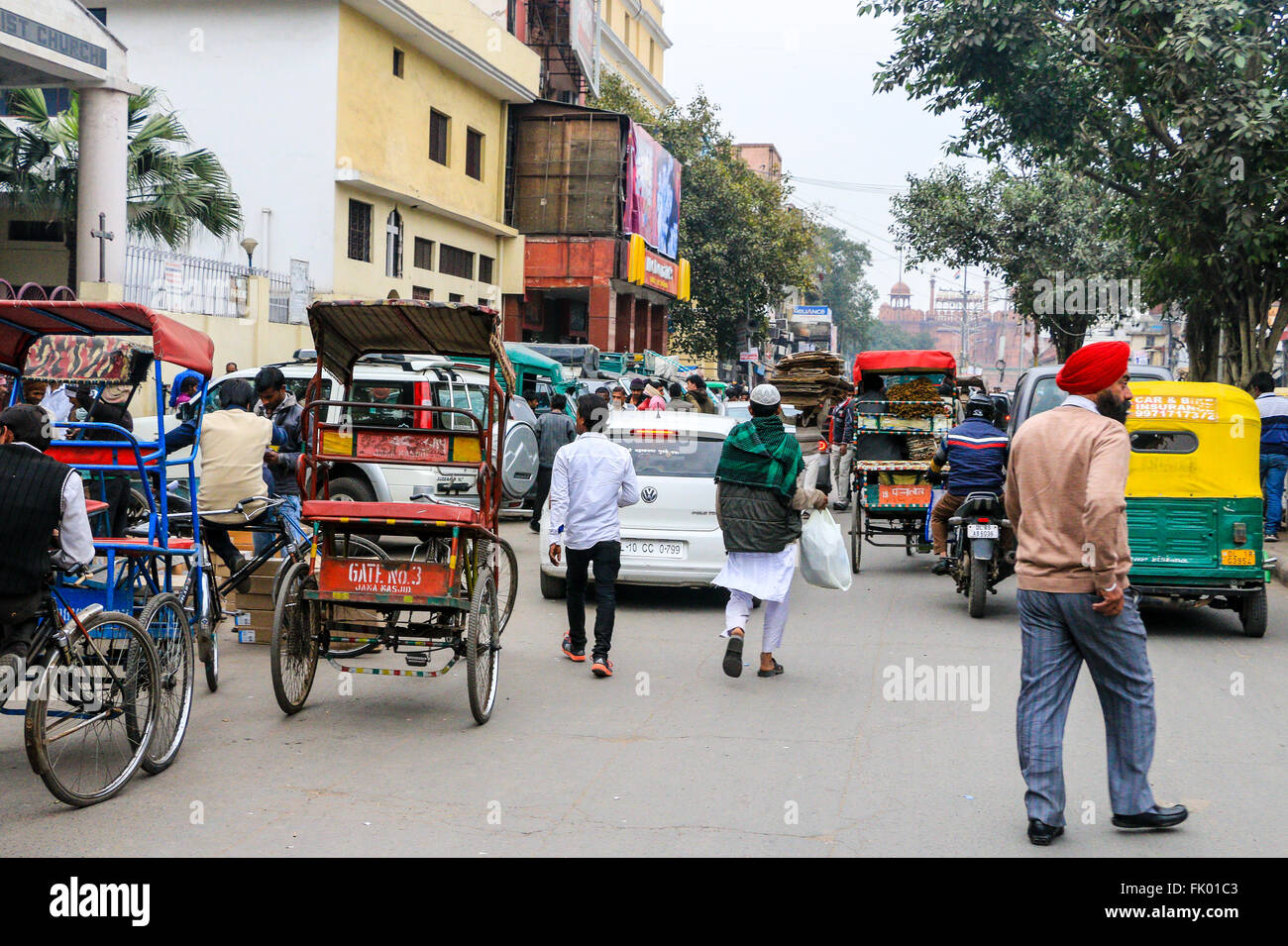 Street scene with pedestrians, rickshaws tuk tuks and cars, Old Delhi ...