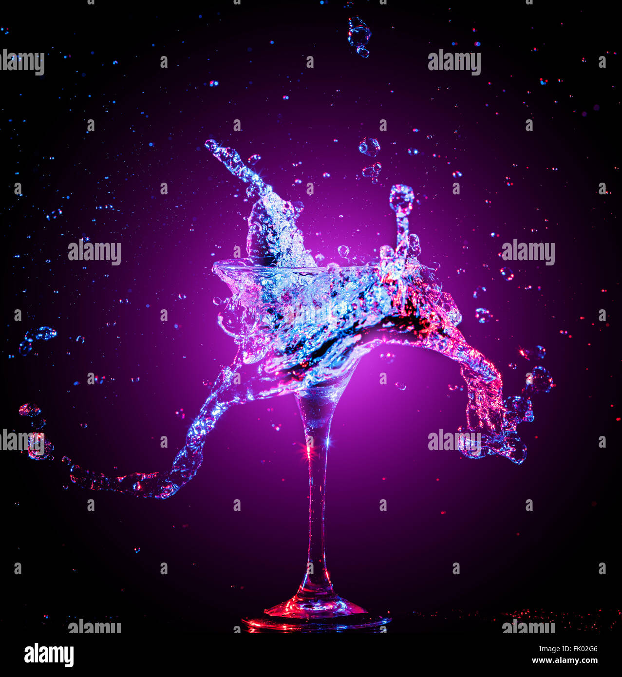 Colourful cocktail in glass with splash Stock Photo - Alamy