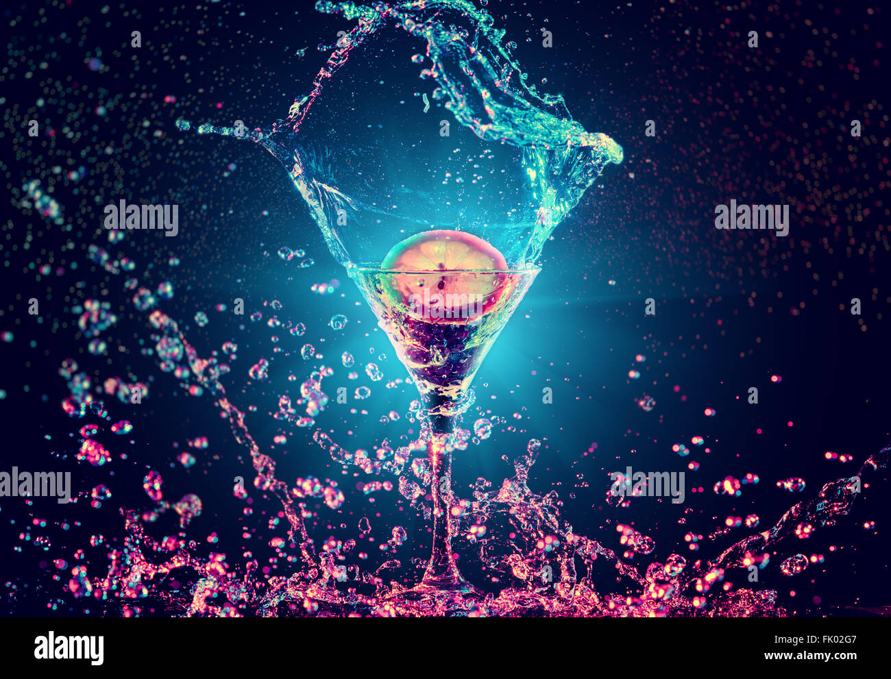 Colourful cocktail in glass with splash Stock Photo - Alamy