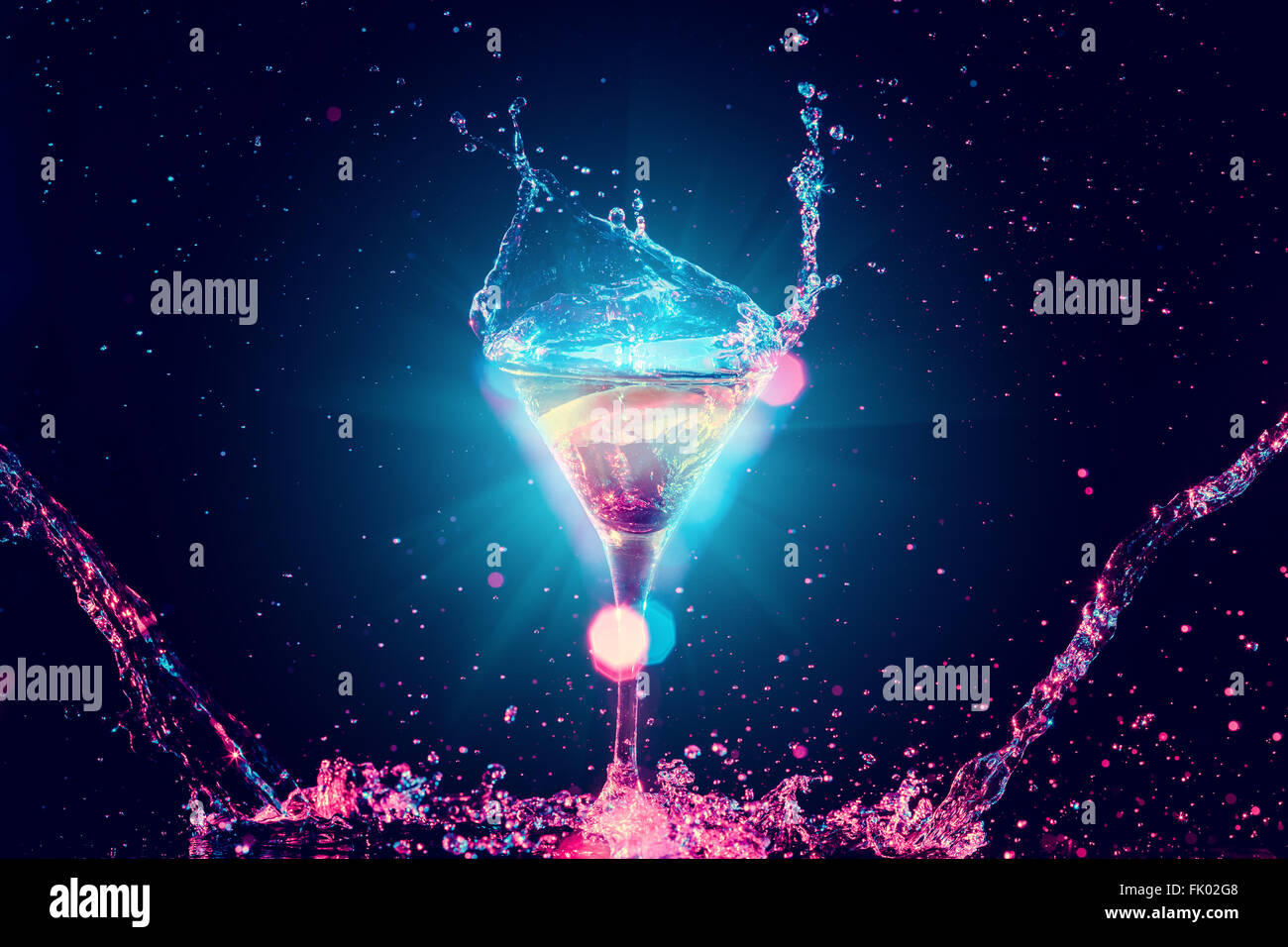 Colourful cocktail in glass with splash Stock Photo - Alamy