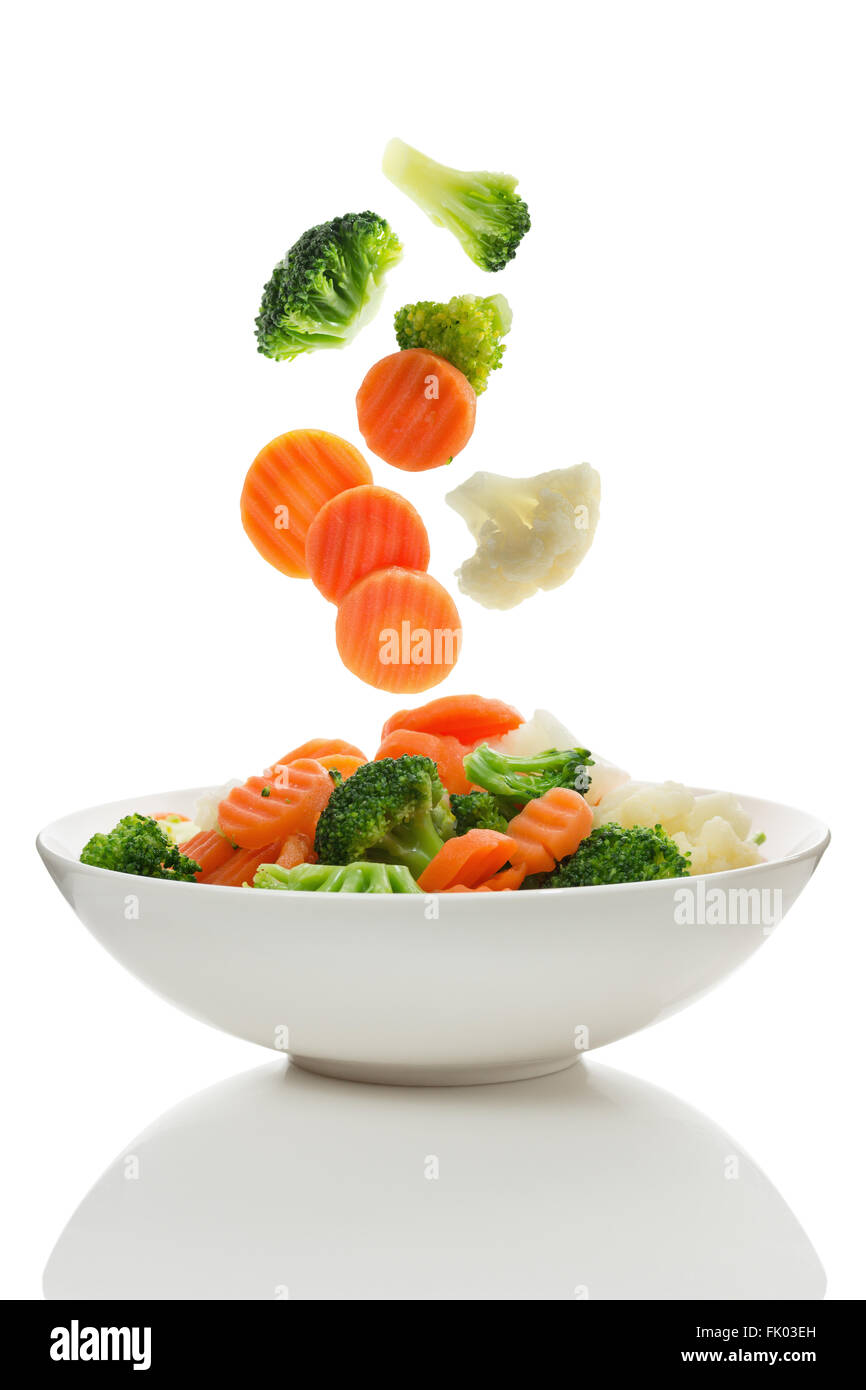 Mixed vegetables falling into a bowl of salad Stock Photo - Alamy