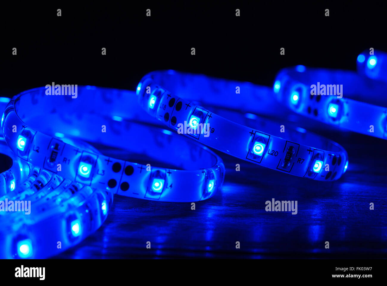 Blue led strip on a wooden board on the black background Stock Photo ...