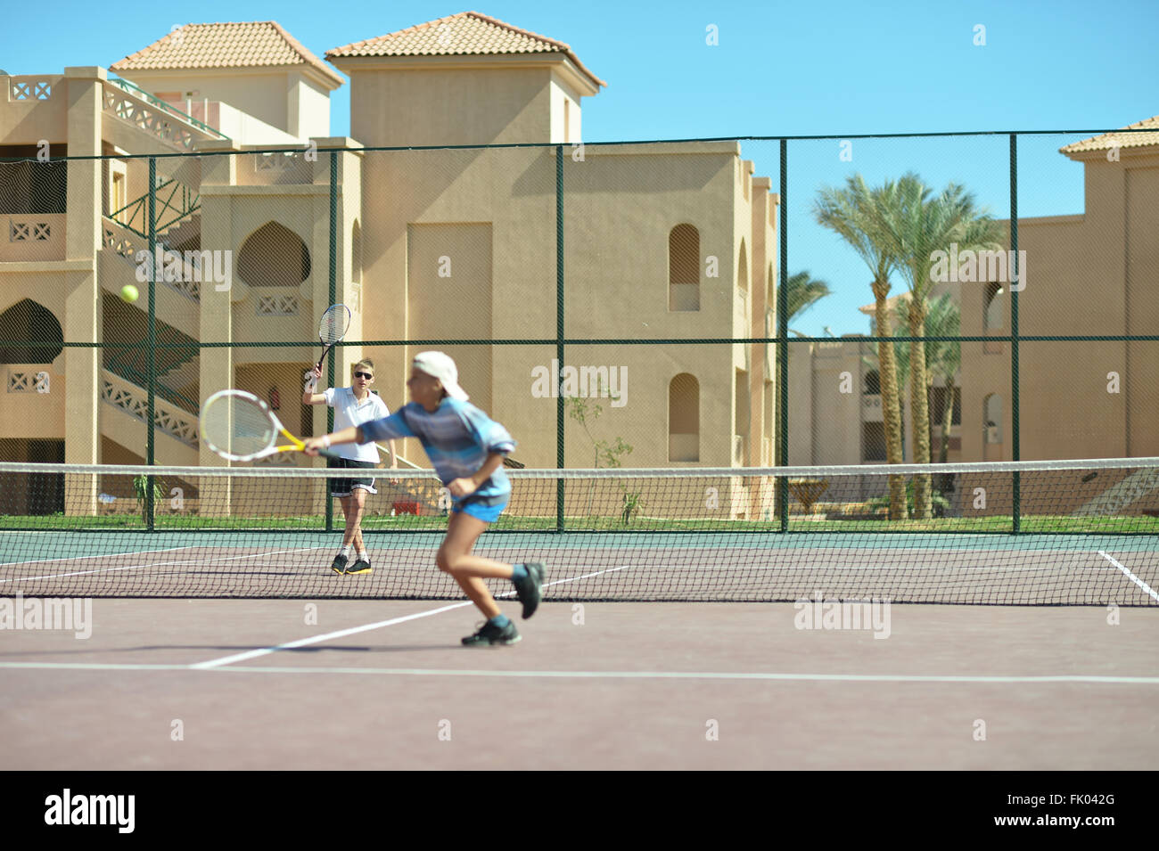 playing at tennis court Stock Photo - Alamy