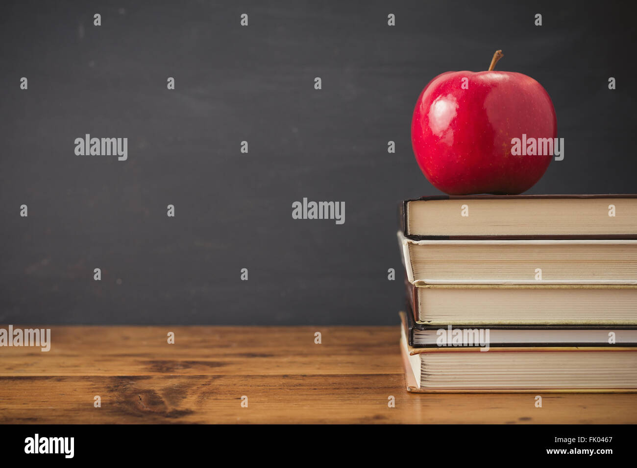 Apple and stack of books Stock Photo - Alamy
