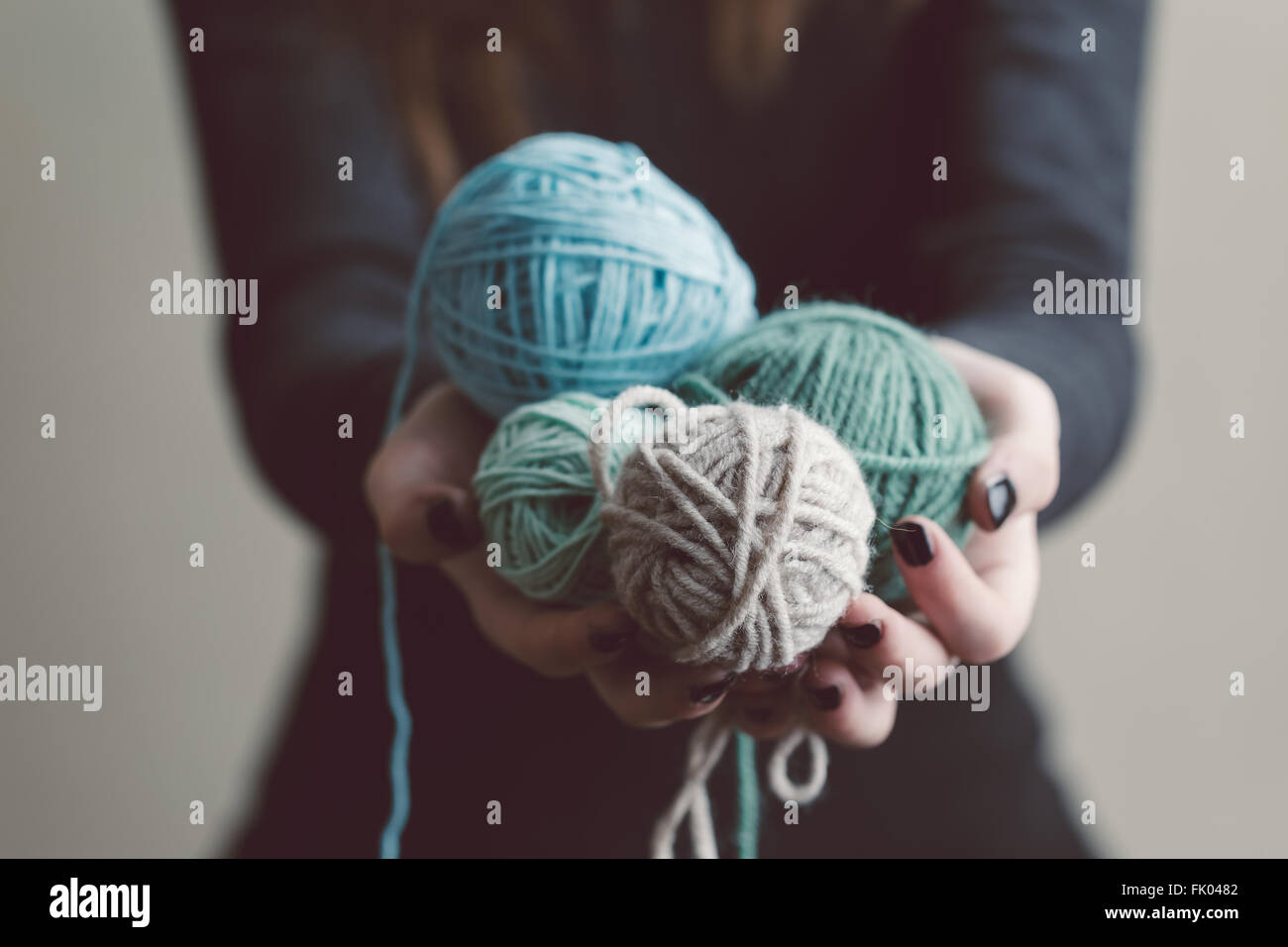 Hands holding a balls of yarn Stock Photo - Alamy