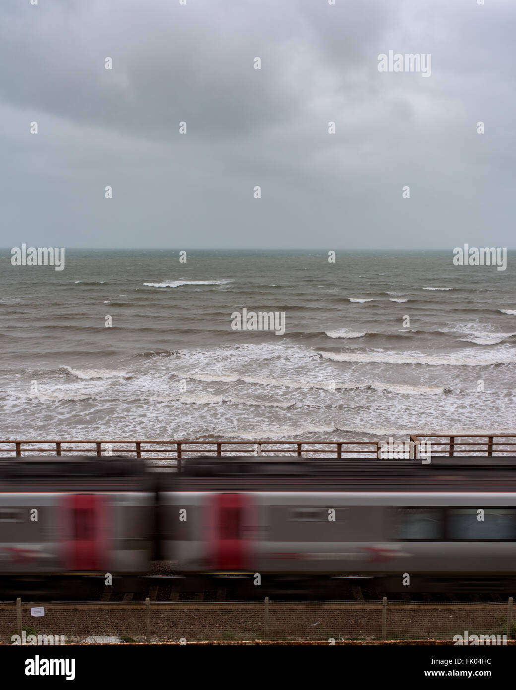 Train traveling on a coastal railway Stock Photo - Alamy