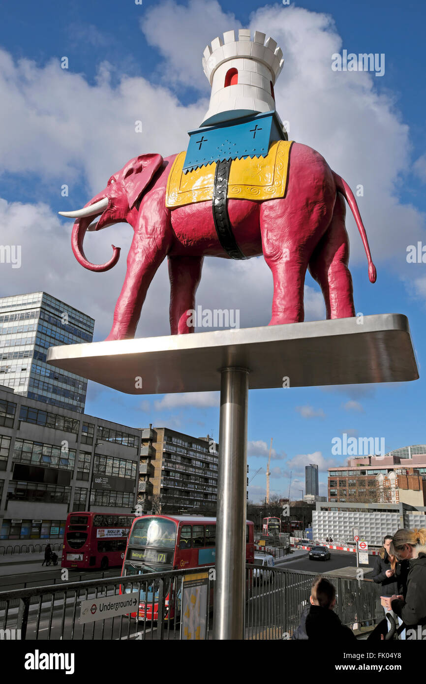 The Elephant & Castle statue and buses in traffic at the roundabout ...