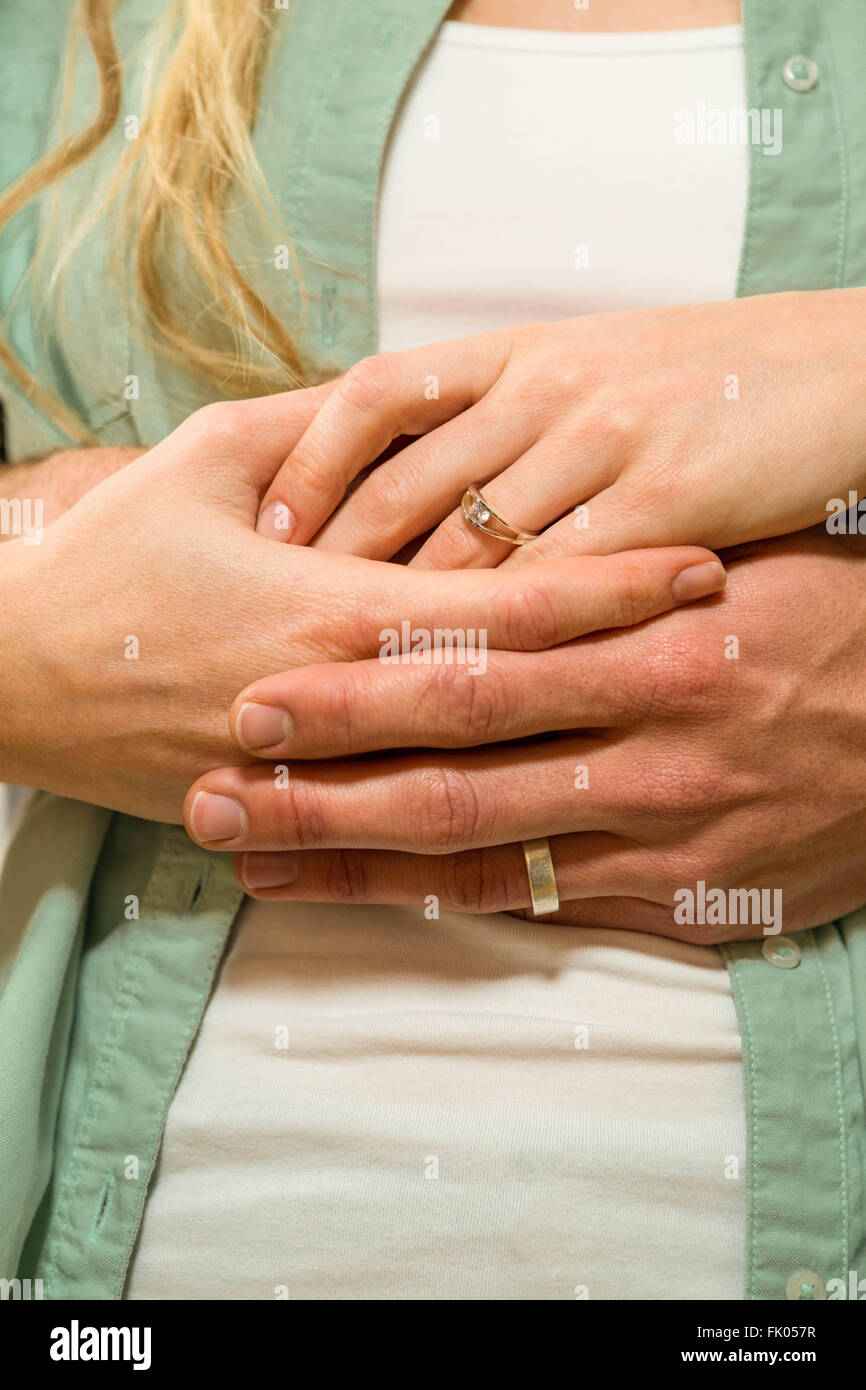 Close up of couple hands wearing wedding rings Stock Photo - Alamy