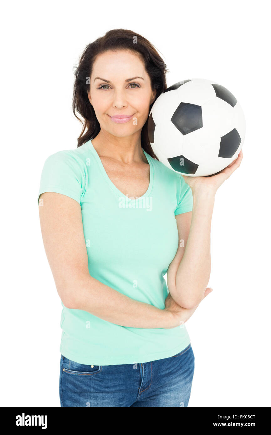 Pretty brunette holding soccer ball Stock Photo - Alamy