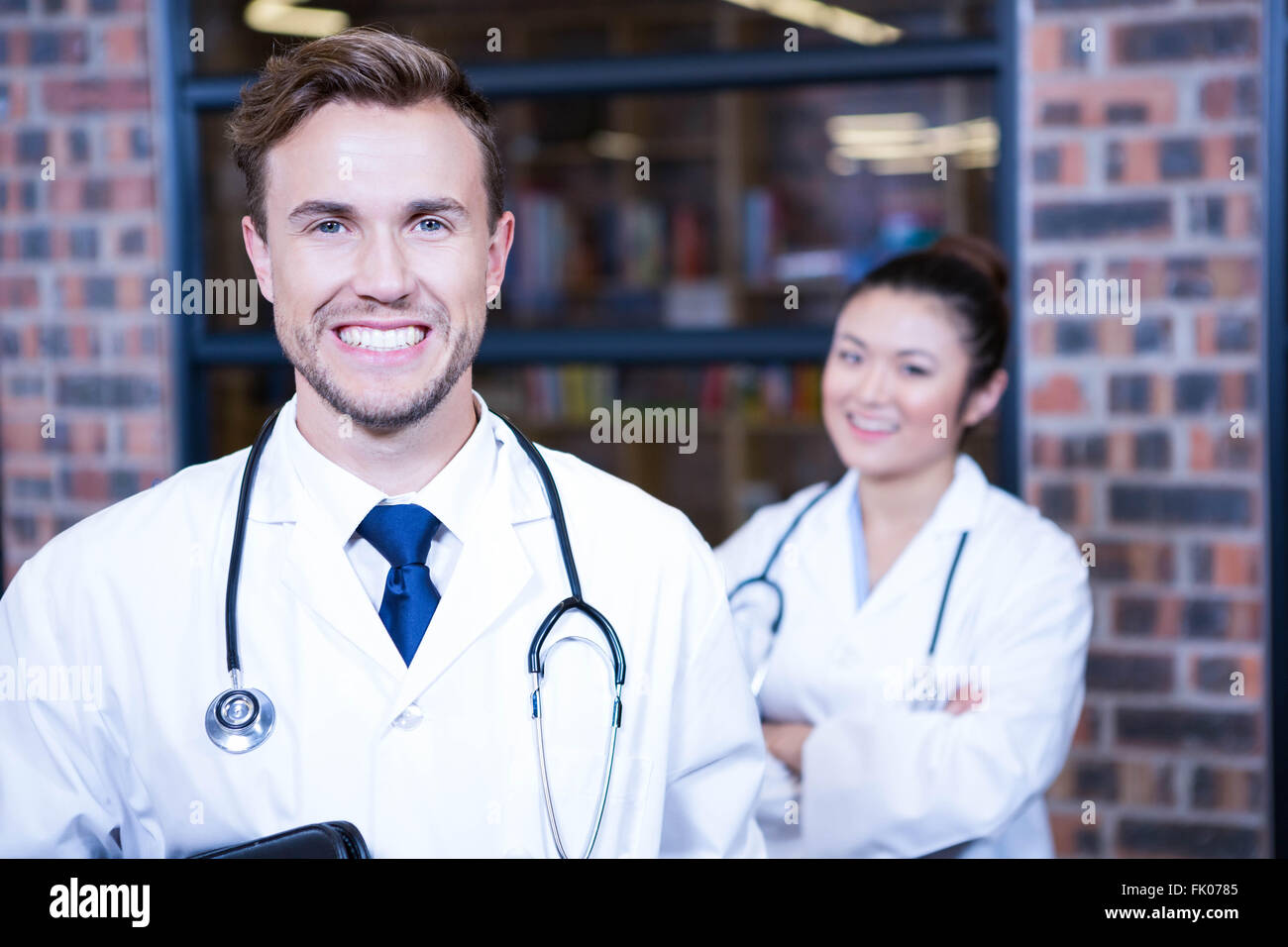 Doctors looking at camera and smiling Stock Photo - Alamy