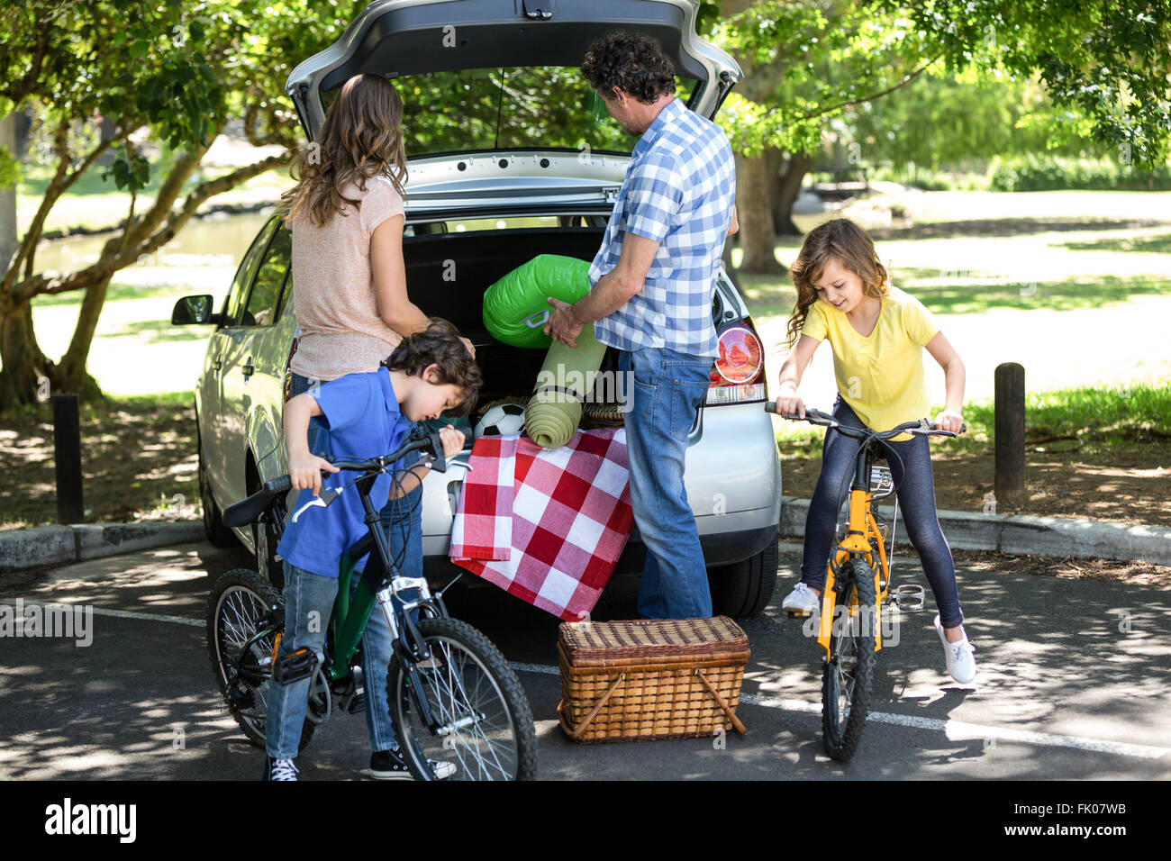 Family in front of a car Stock Photo - Alamy