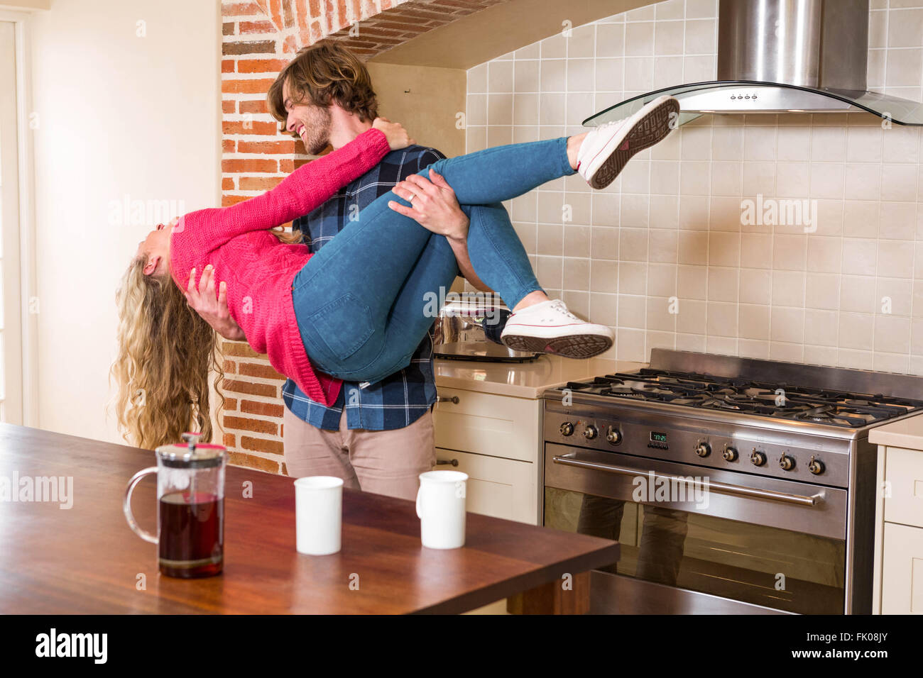 Cute couple having fun and boyfriend picking up girlfriend Stock Photo ...