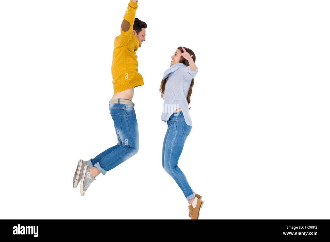 Happy couple jumping together Stock Photo - Alamy