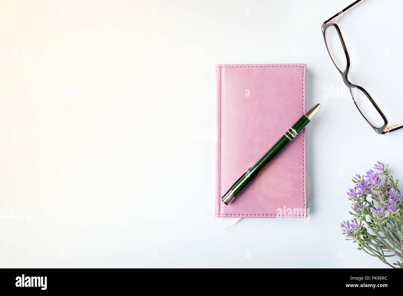 closed notebook with pen on blue table, flat lay Stock Photo - Alamy