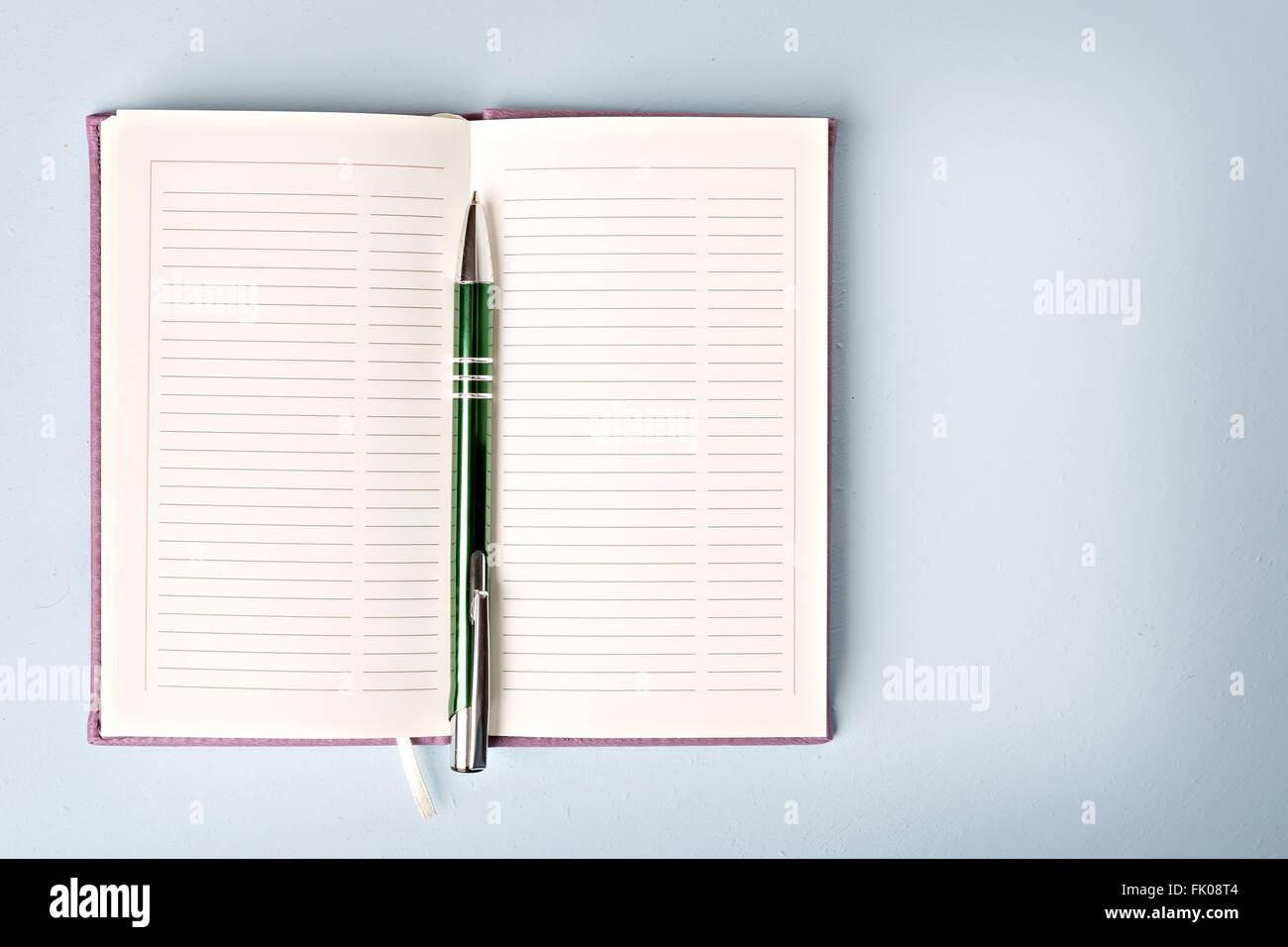 opened notebook with pen on blue table, flat lay Stock Photo - Alamy
