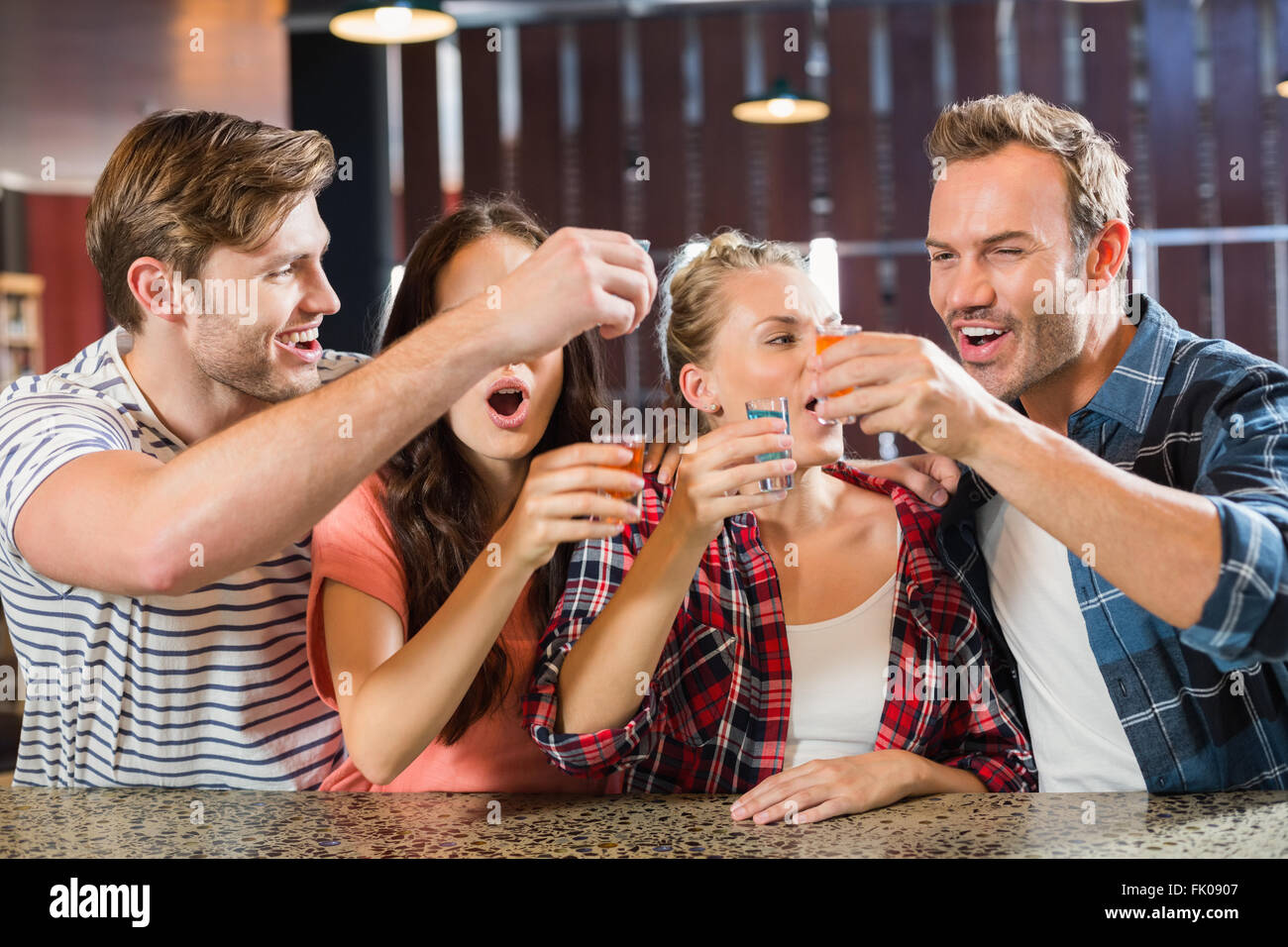 Friends toasting with shots Stock Photo - Alamy