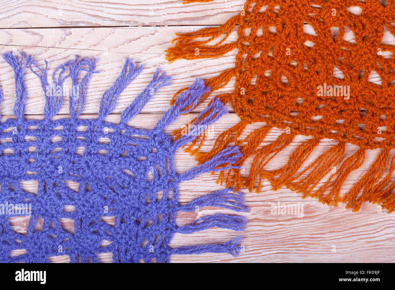 Knitted woolen female shawls on wooden background Stock Photo - Alamy