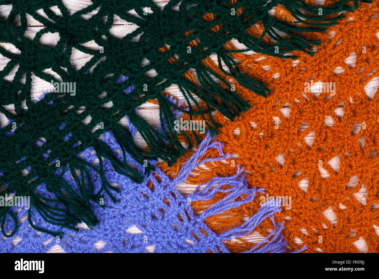 Knitted woolen female shawls on wooden background Stock Photo - Alamy