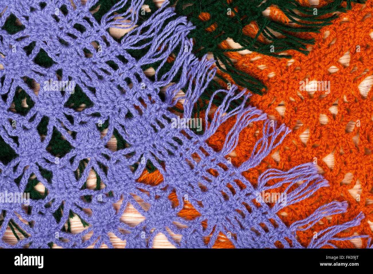 Knitted woolen female shawls on wooden background Stock Photo - Alamy