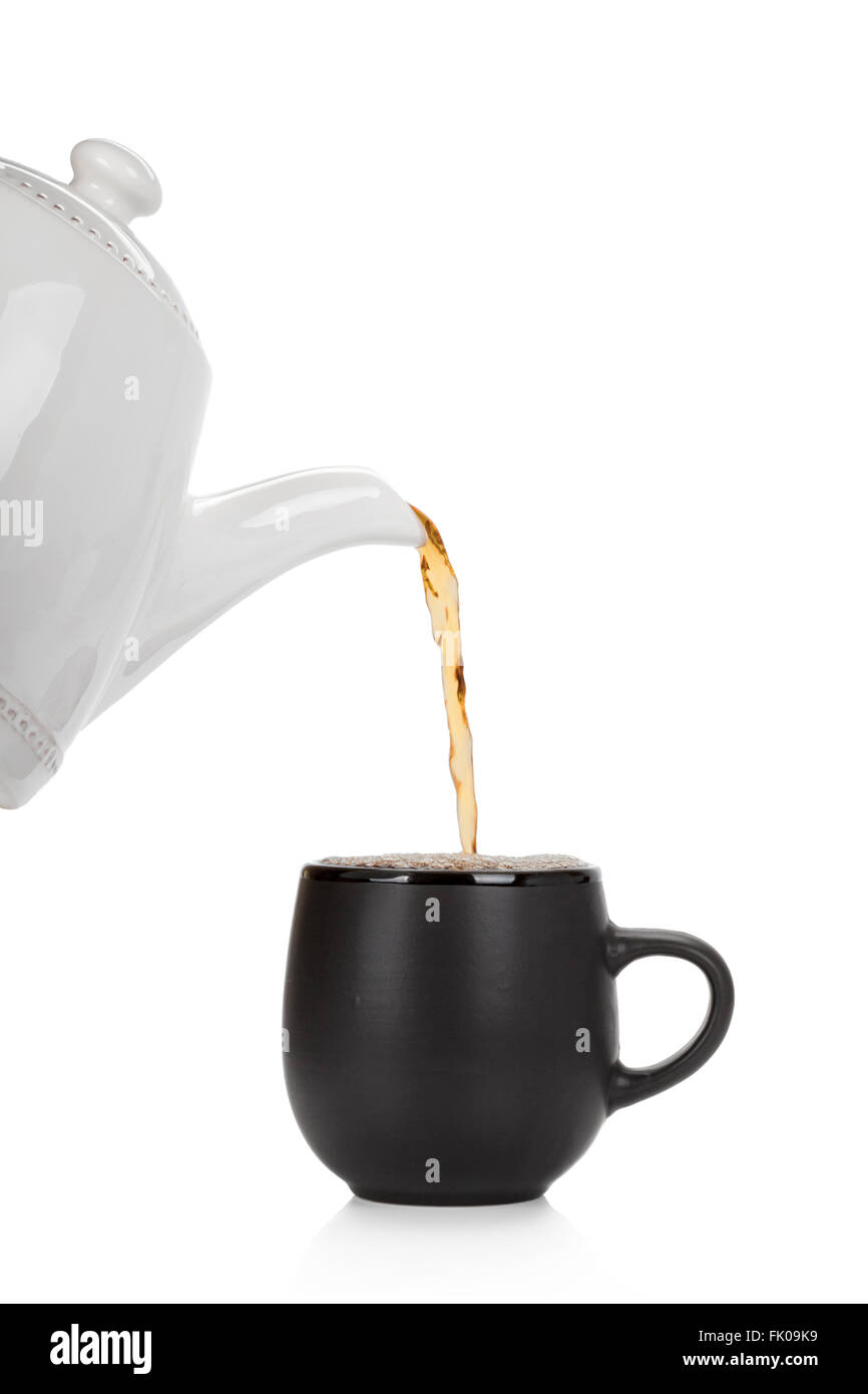 Pouring tea into a cup isolated on white background Stock Photo - Alamy