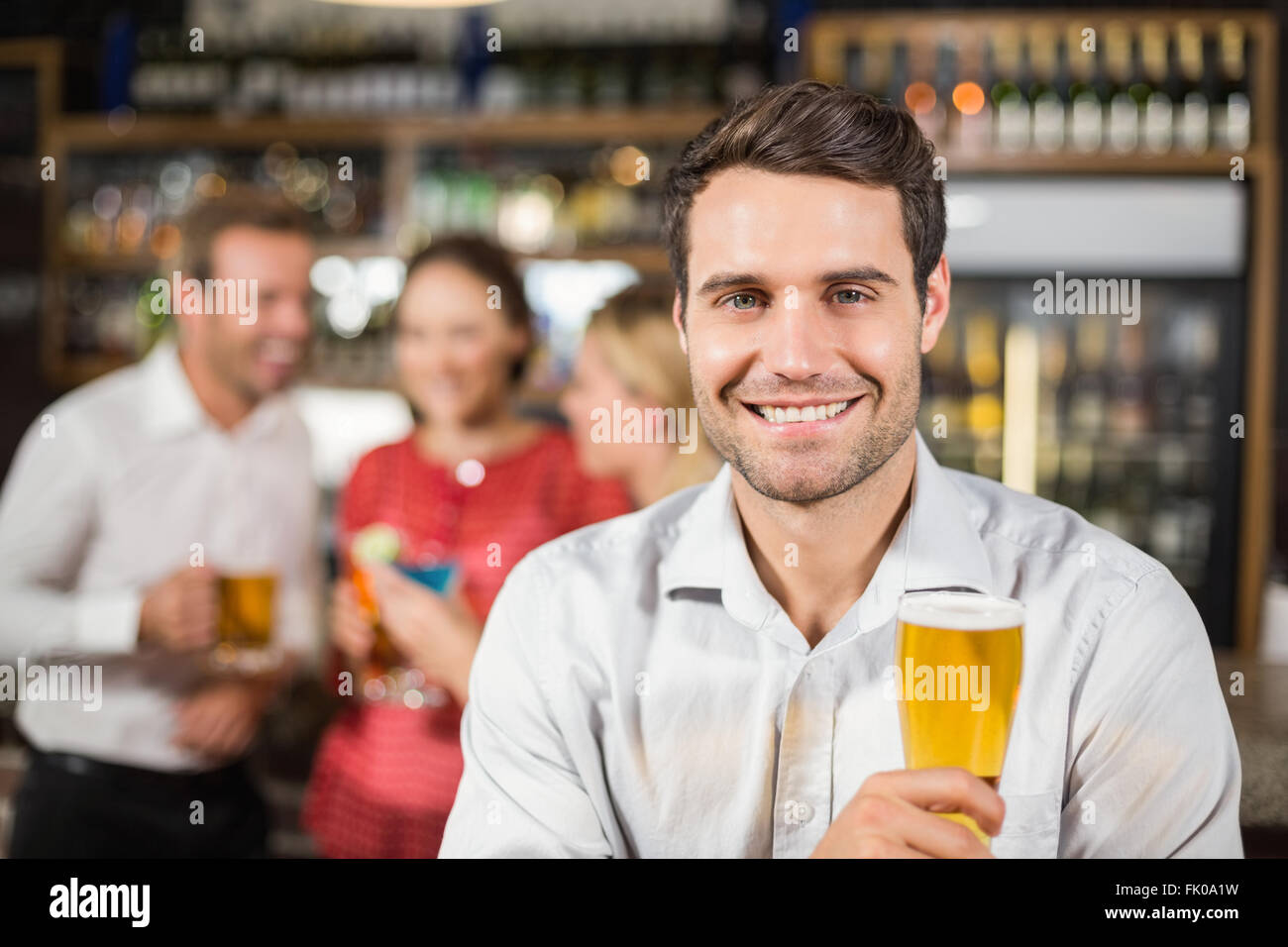 Man holding beer smiling hi-res stock photography and images - Alamy