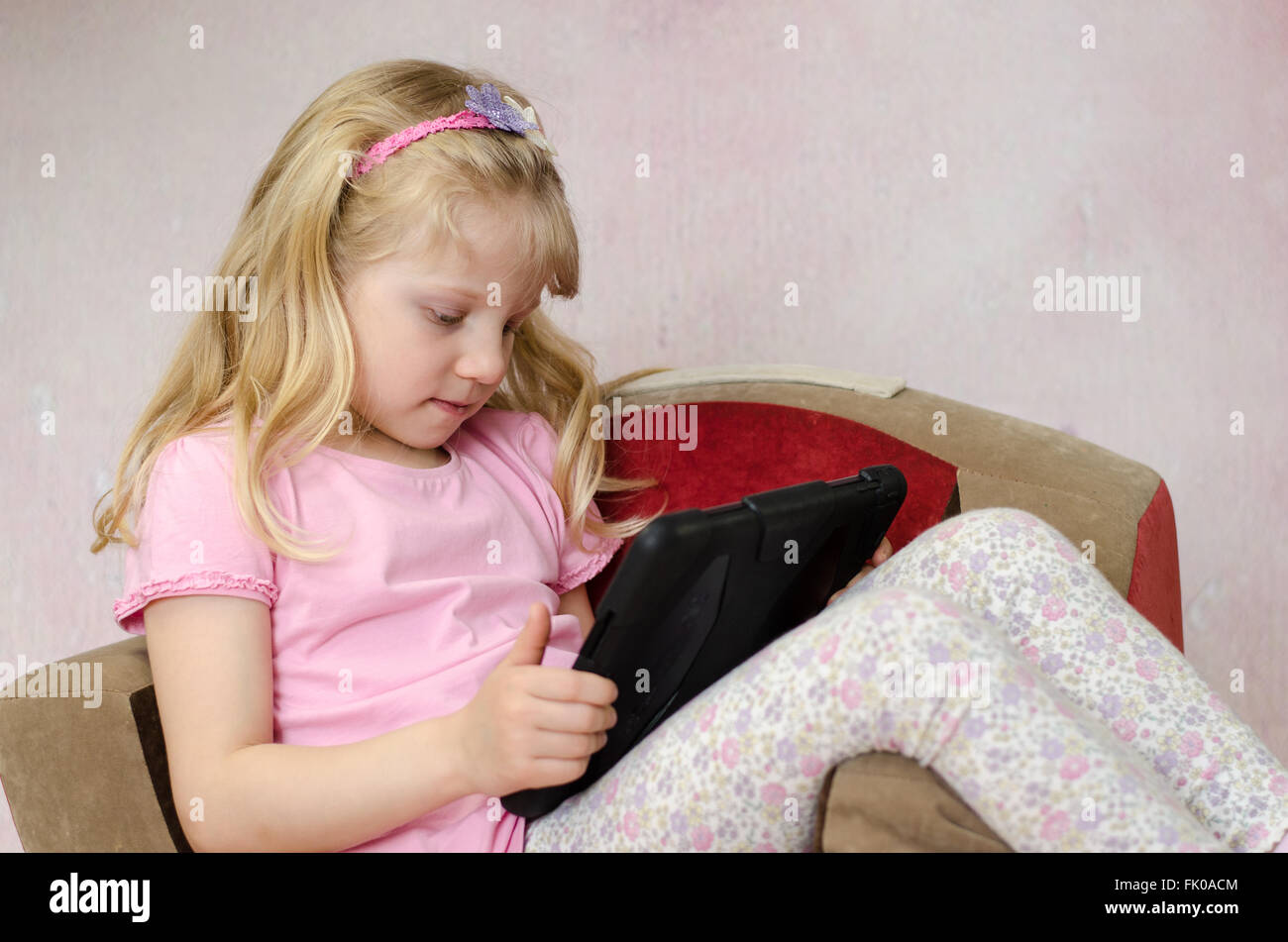 beautiful girl playing with tablet Stock Photo - Alamy