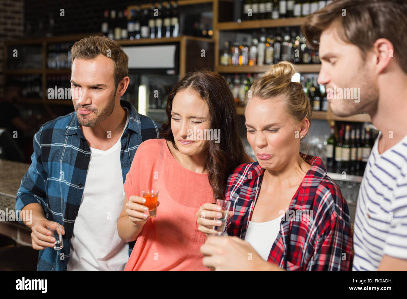 Friends making faces because of shots Stock Photo - Alamy
