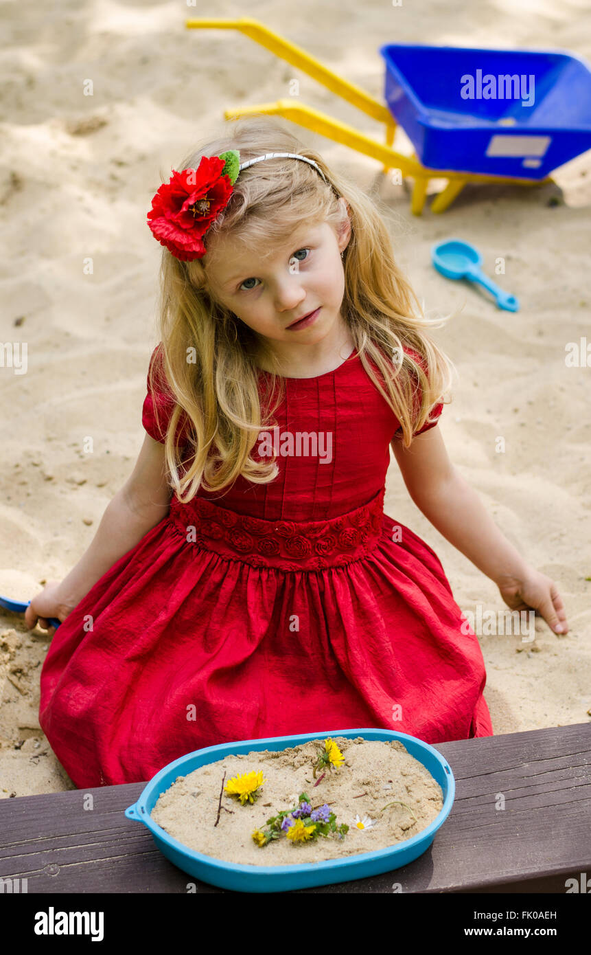 adorable blond girl playing in sandbox Stock Photo - Alamy