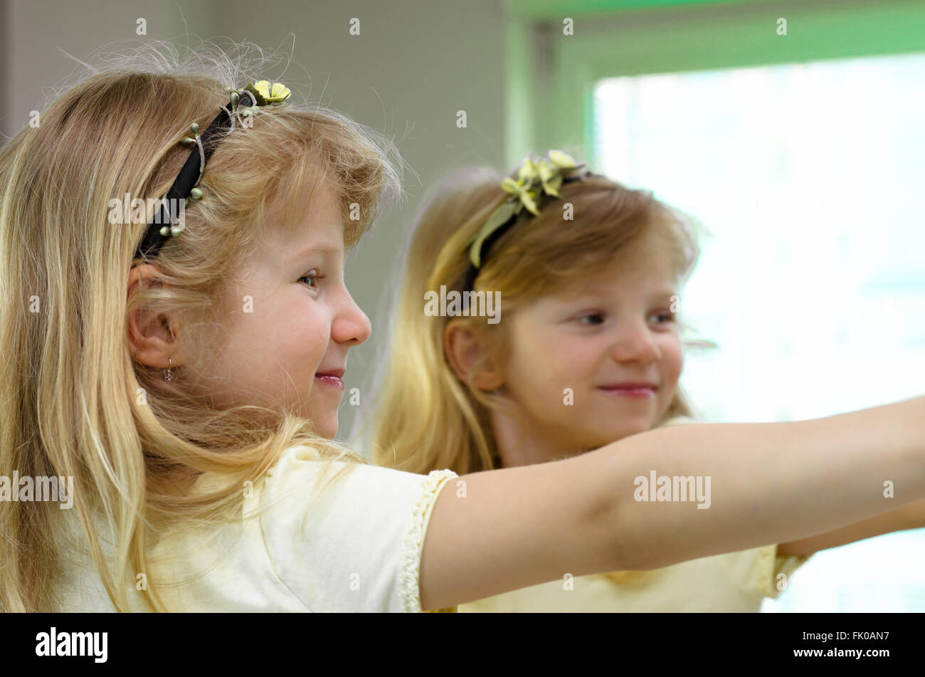 beautiful blond girl reflection in mirror Stock Photo - Alamy