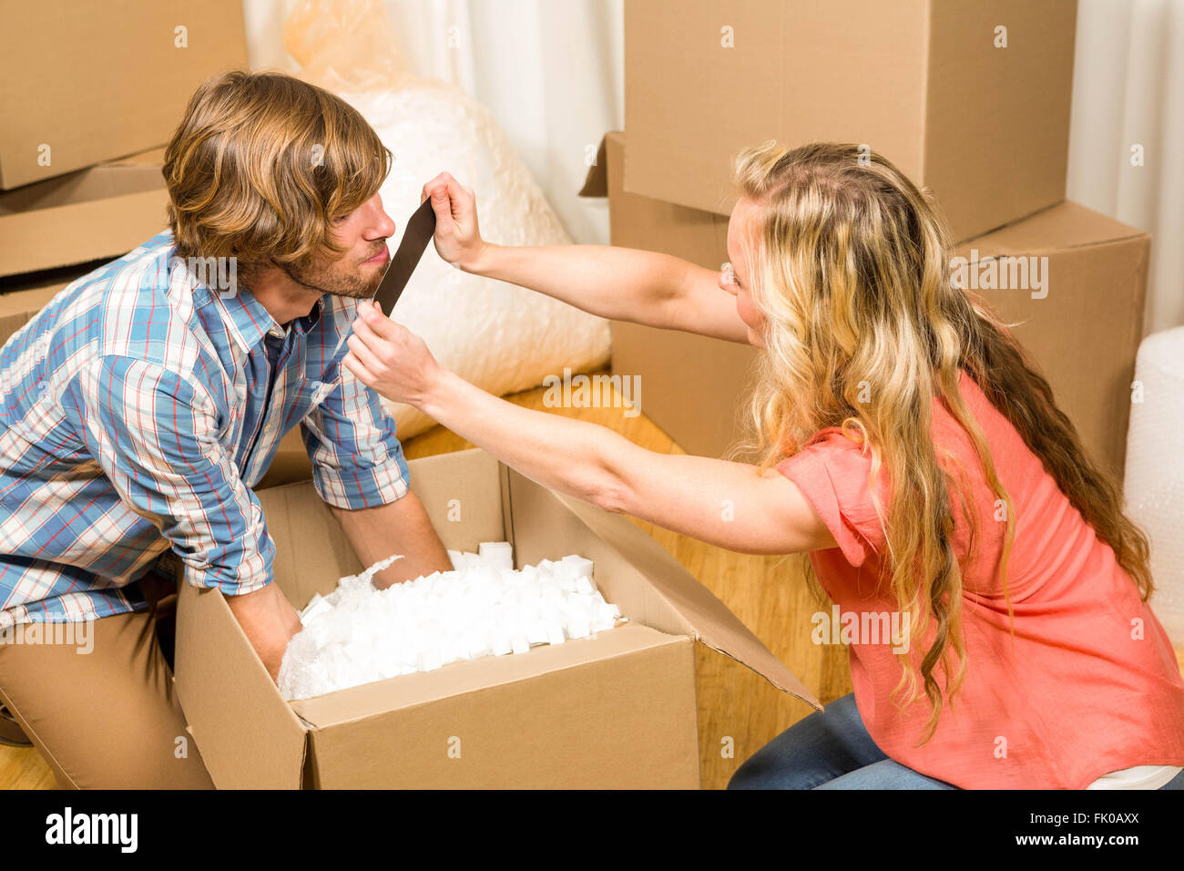 Happy couple unpacking after move Stock Photo - Alamy