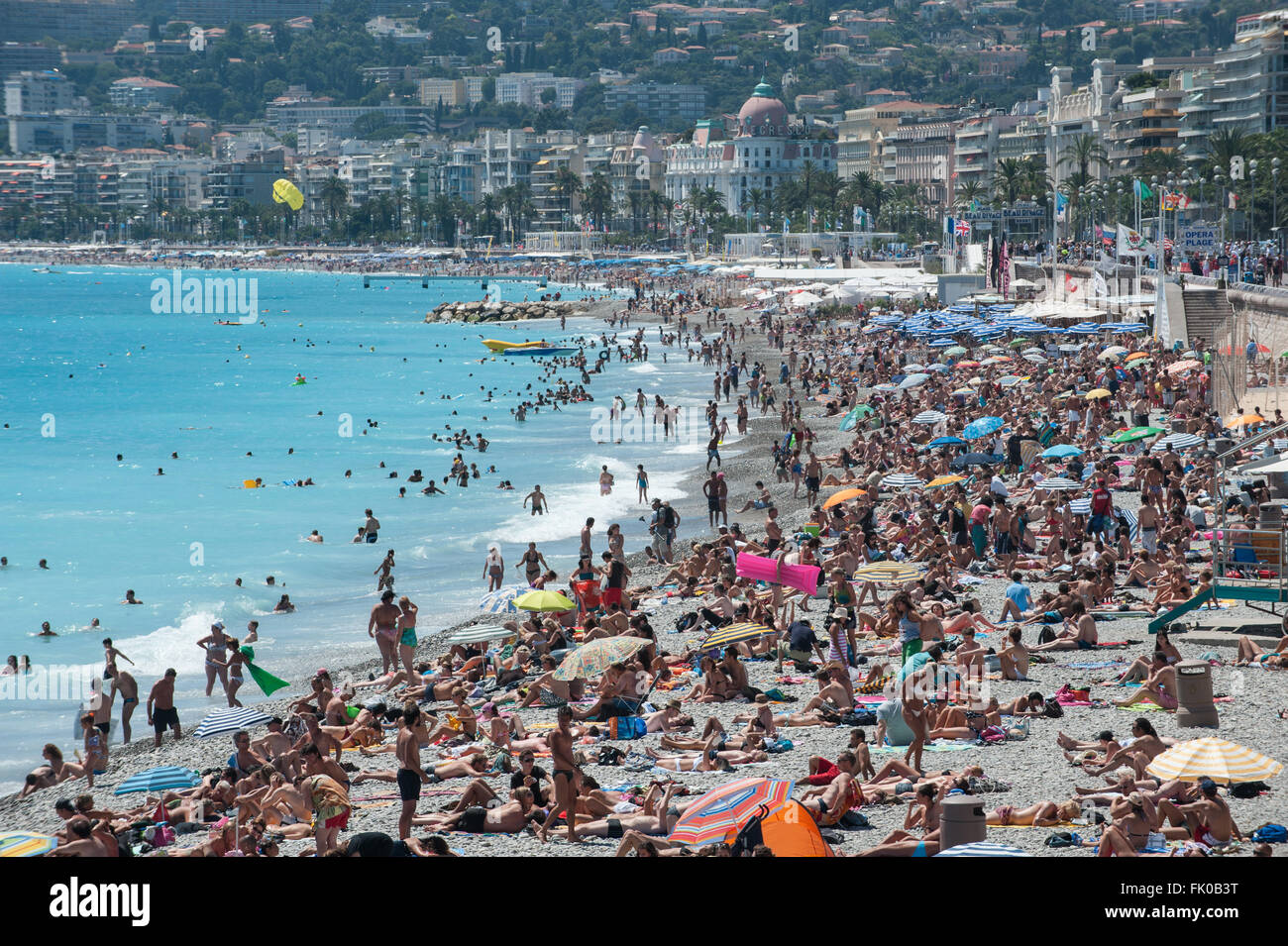 The busy crowded beach at Nice in the height of Summer in July Stock ...
