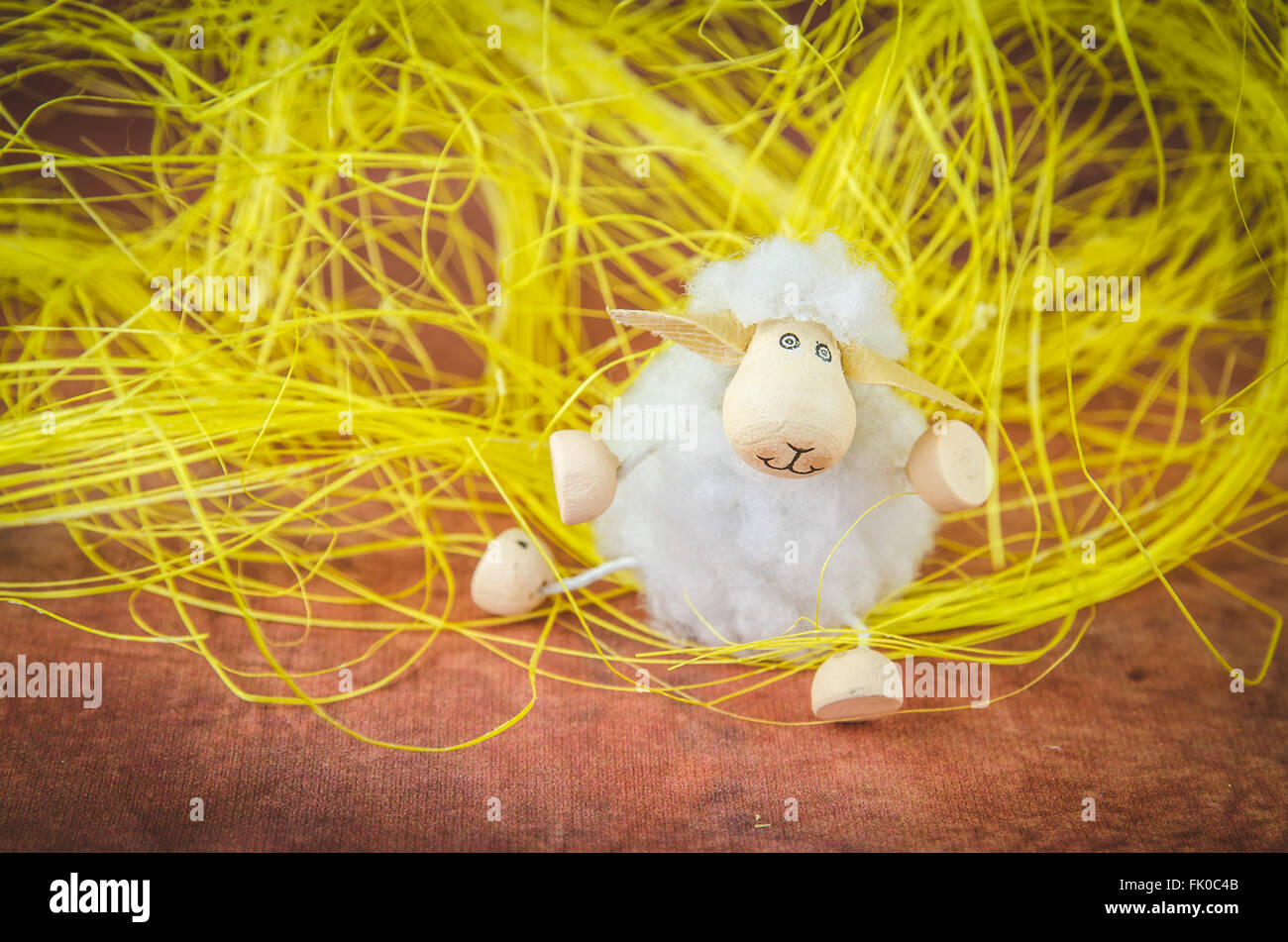 Easter sheep decoration against brown background Stock Photo - Alamy