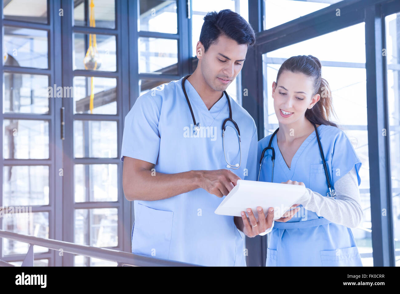 Health care workers colleagues talking hi-res stock photography and ...