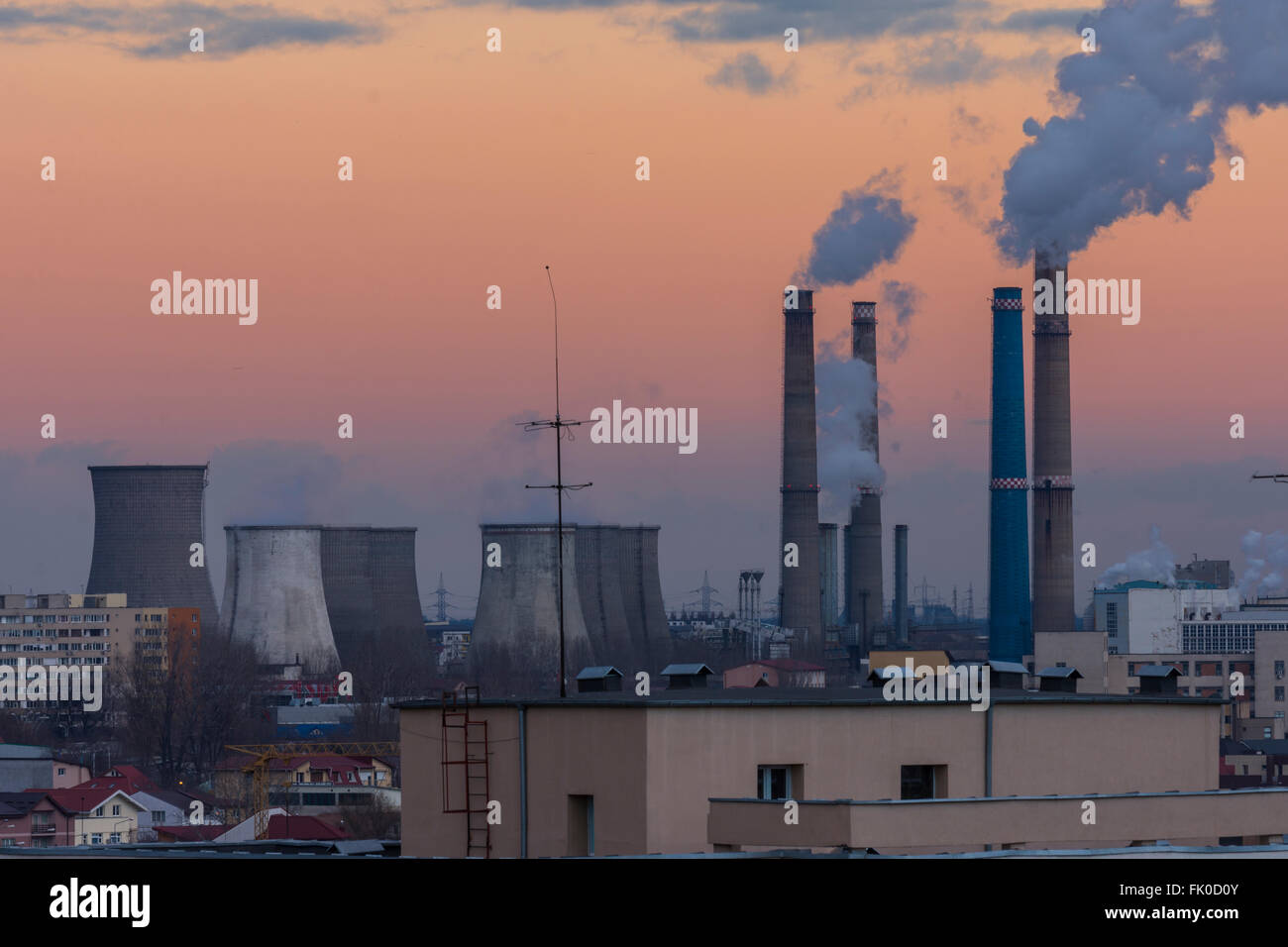 Power plant polluting the environment in city Stock Photo - Alamy