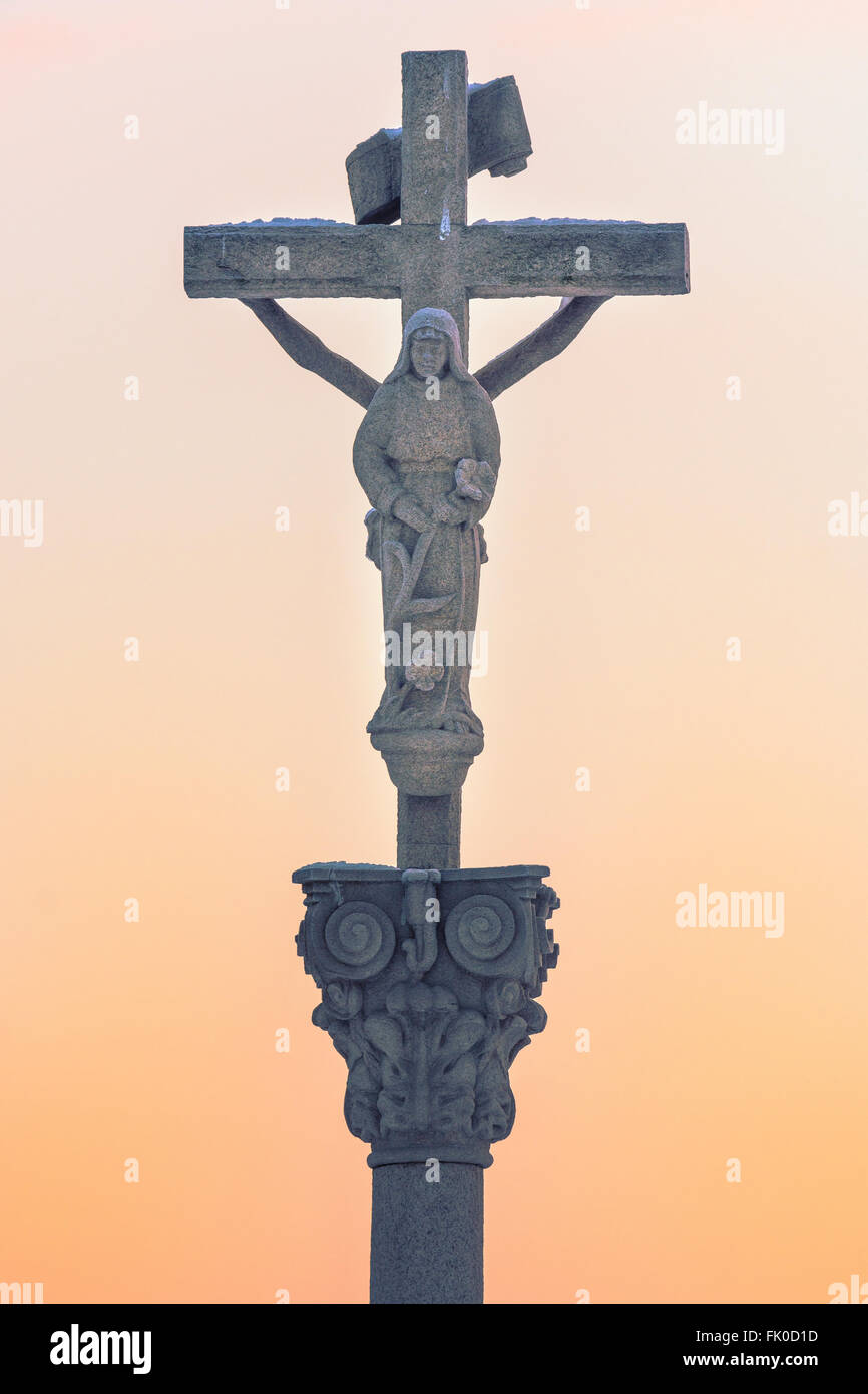 Cross made of stone with Virgin Mary at sunrise Stock Photo - Alamy