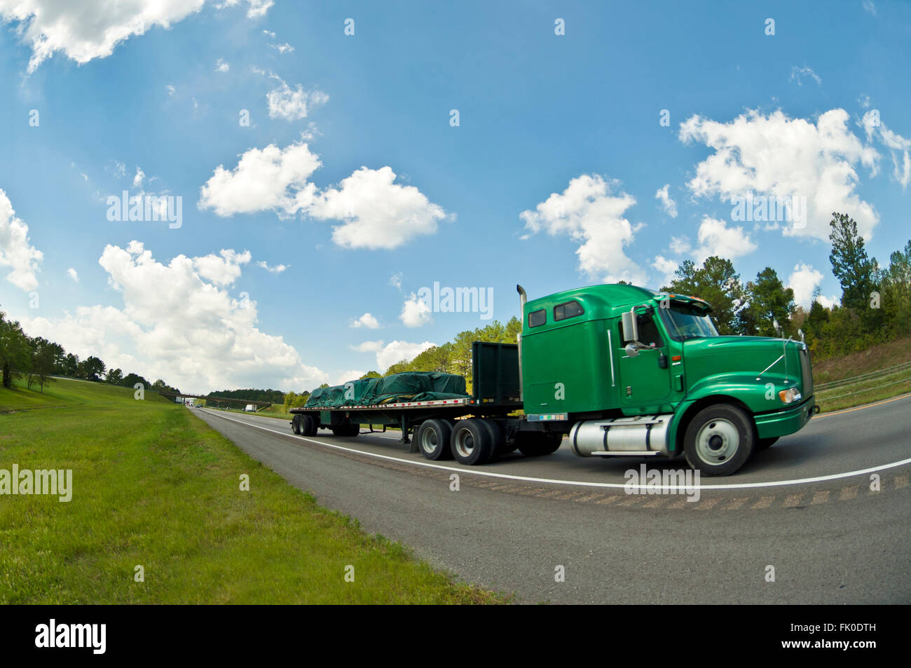 Green Semi Truck Speeds Down Highway Stock Photo - Alamy