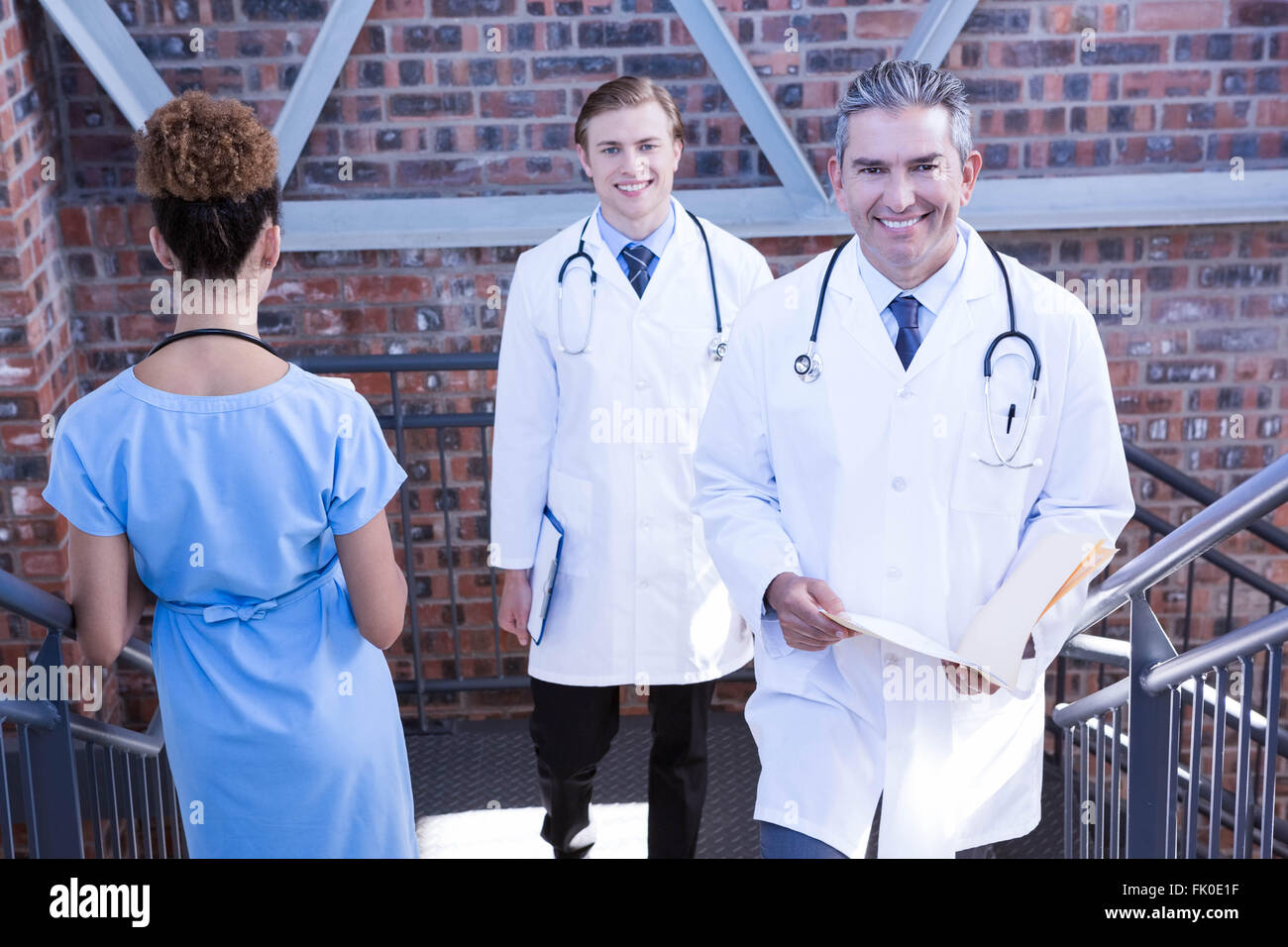 Doctors walking on staircase Stock Photo - Alamy