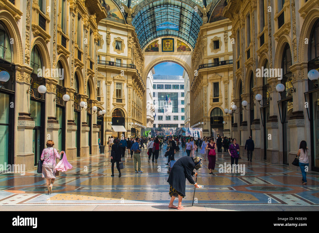 Poor women in the Fashion Galleria in Milan with tourists inside Stock ...