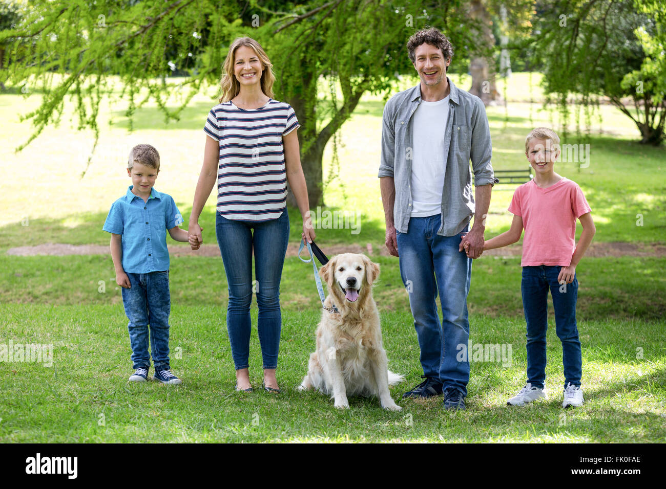 Family with dog in the park Stock Photo - Alamy