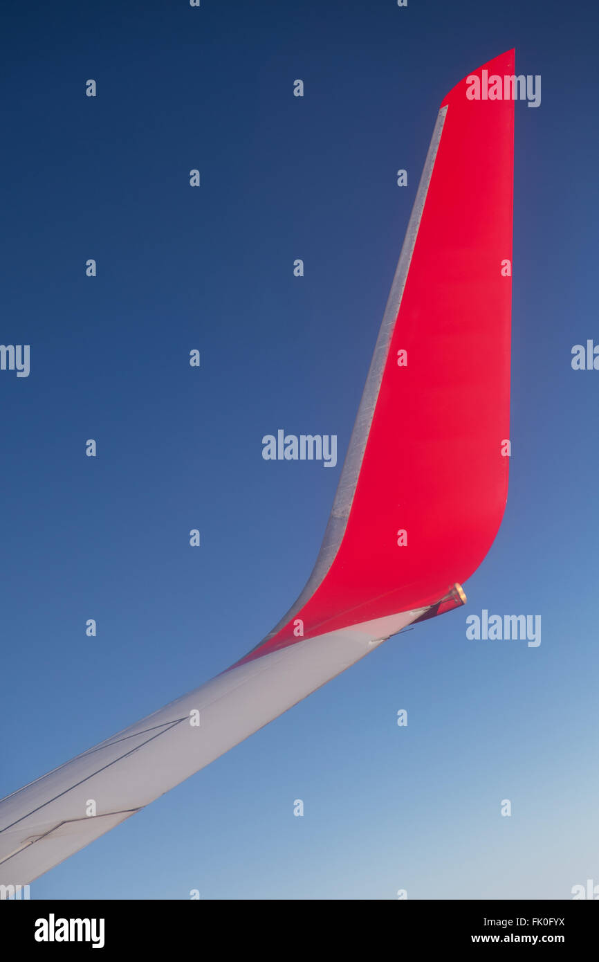 Red Airplane Wing and Wingtrip on sky Stock Photo - Alamy