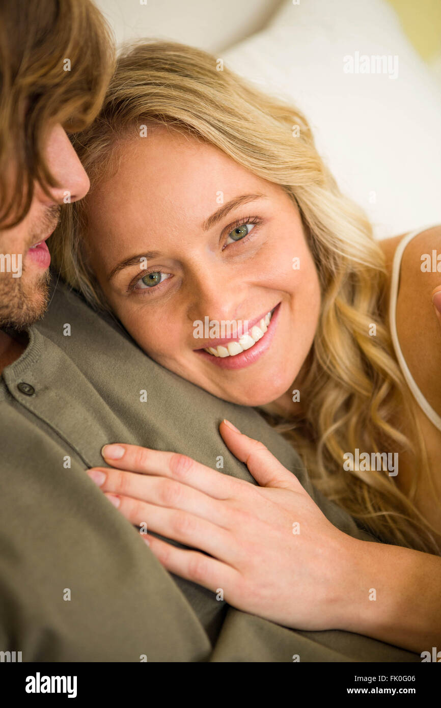 Cute couple cuddling on their bed Stock Photo - Alamy