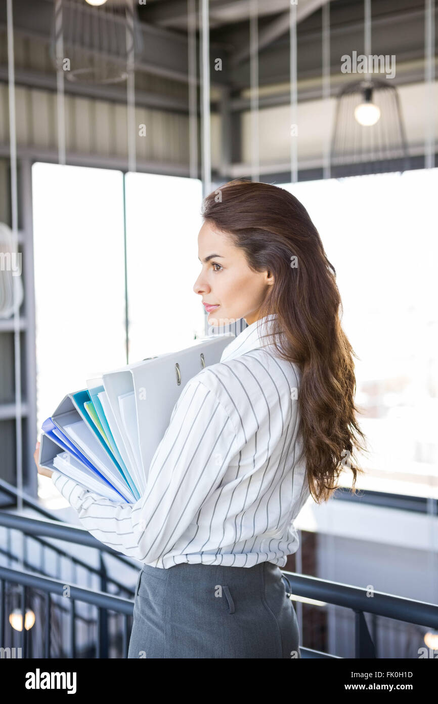 Busy businesswoman carrying folders with files documents Stock Photo ...
