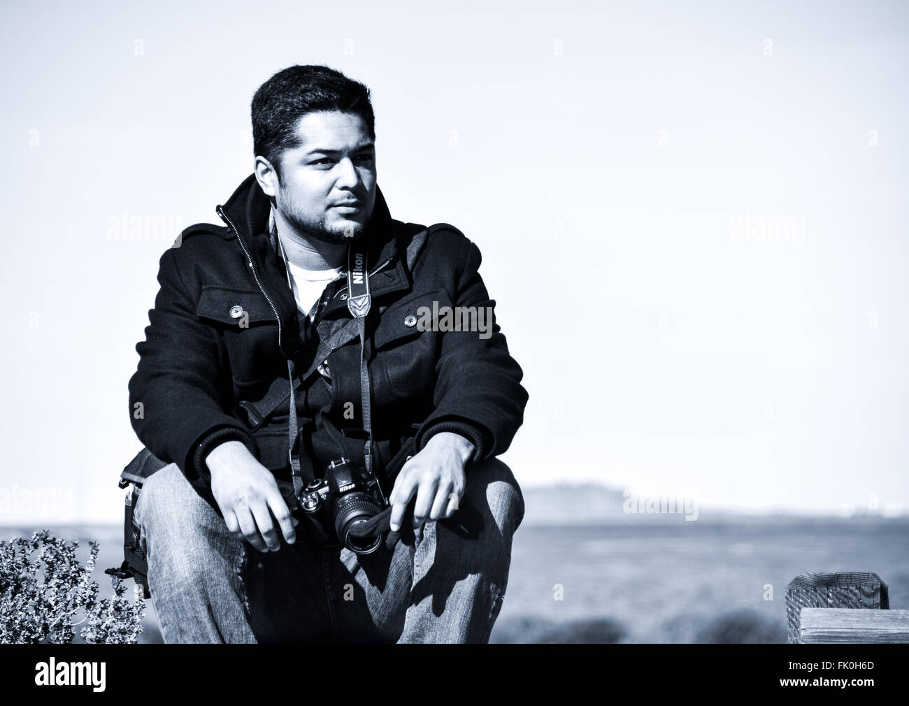 Man sitting with camera Stock Photo - Alamy