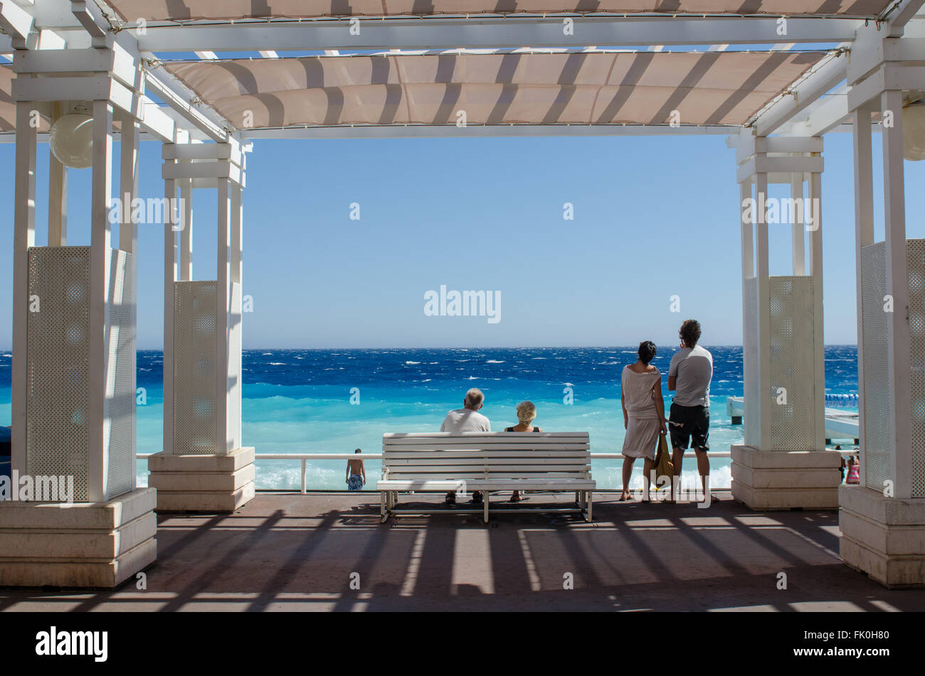 Holidaymakers sitting in the shade of a large pergola on the Promenade ...