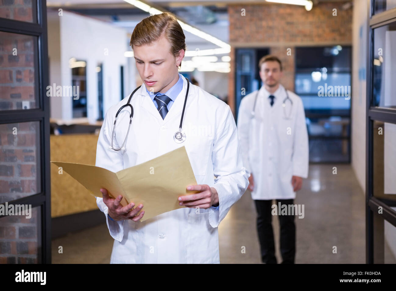 Doctor checking a medical report Stock Photo - Alamy