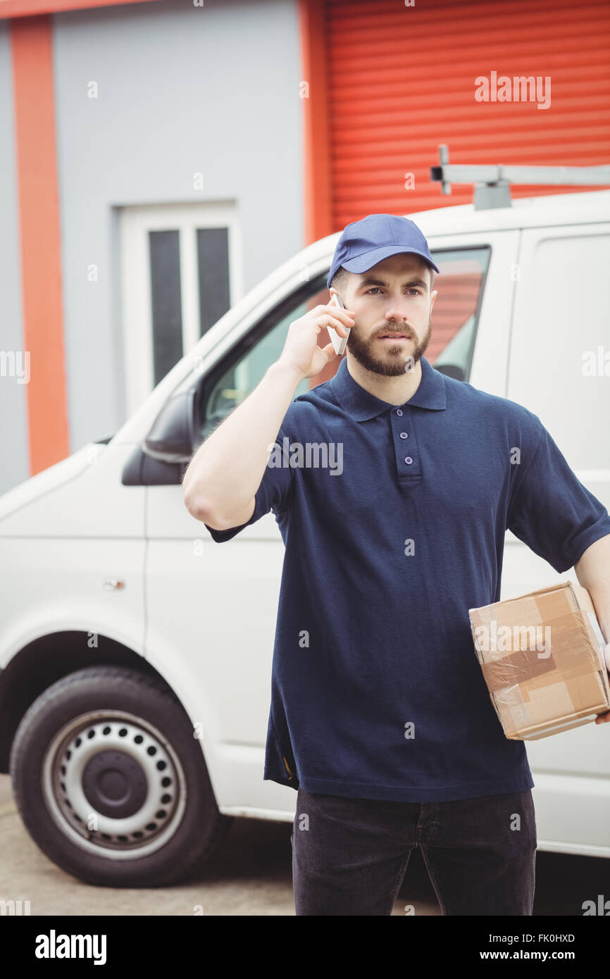 Delivery man making a phone call Stock Photo - Alamy
