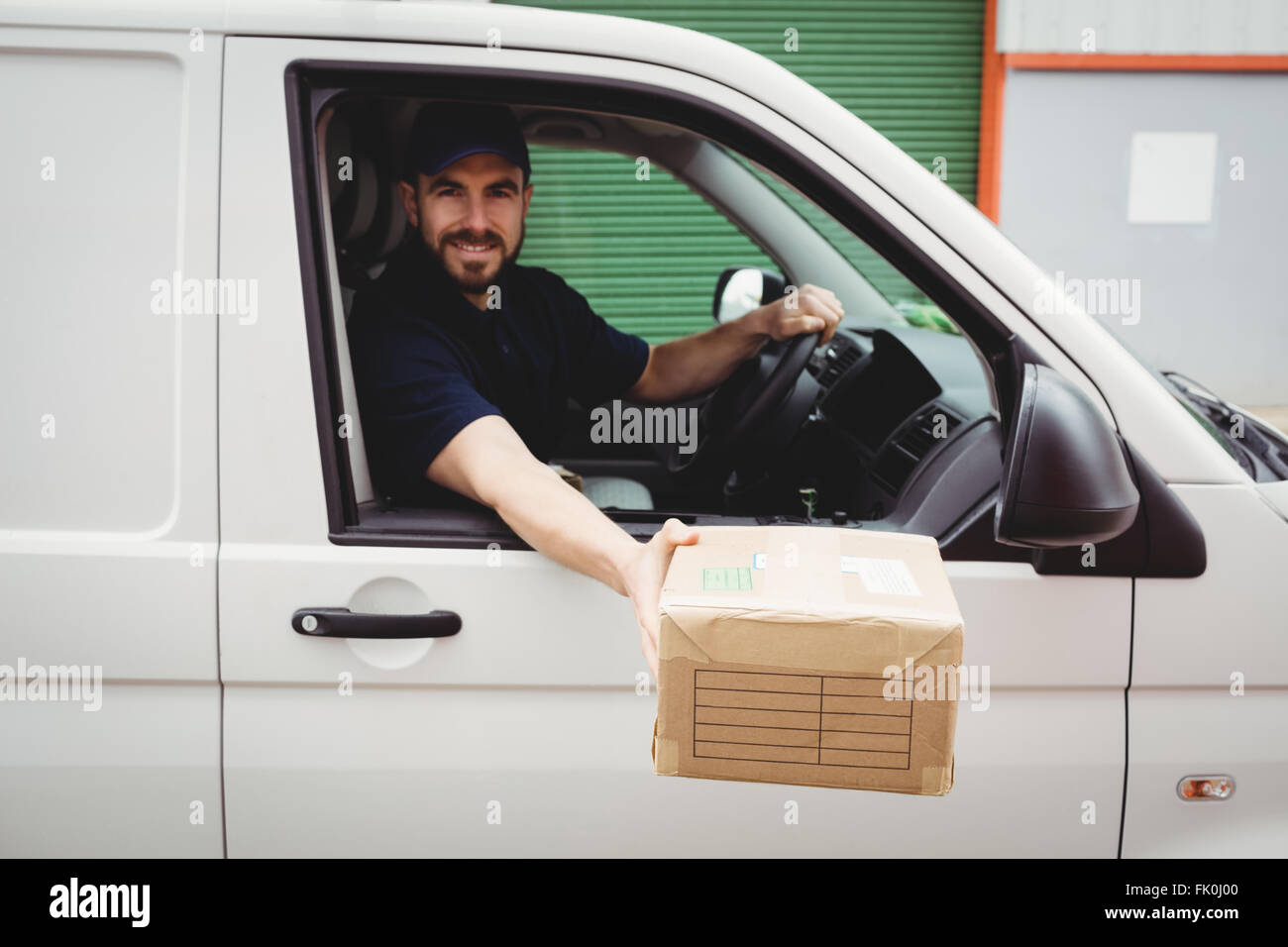 Delivery man sitting in his van Stock Photo - Alamy