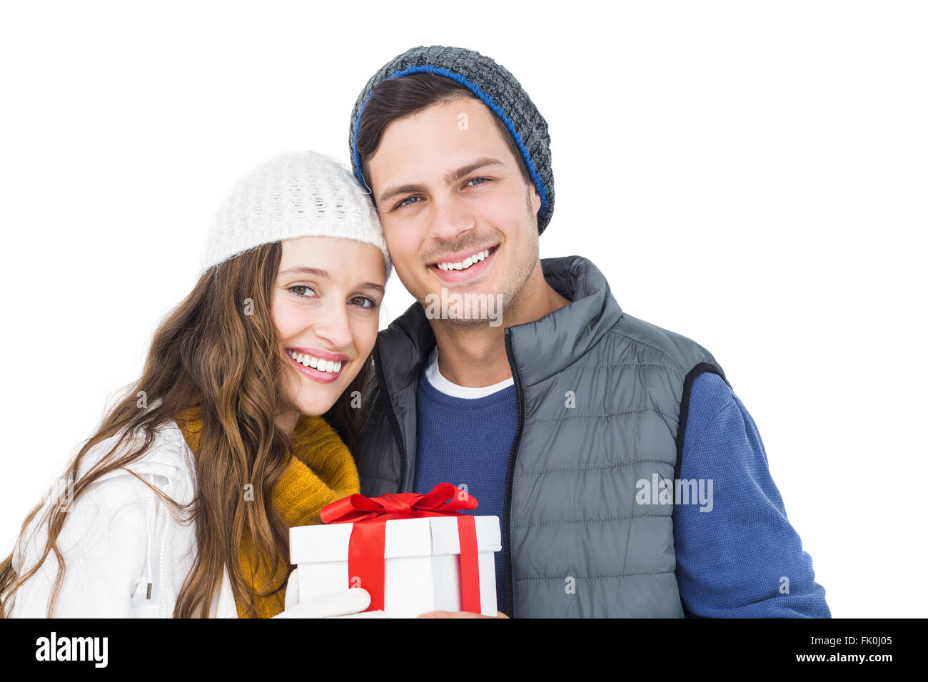Happy couple holding gift box together Stock Photo - Alamy