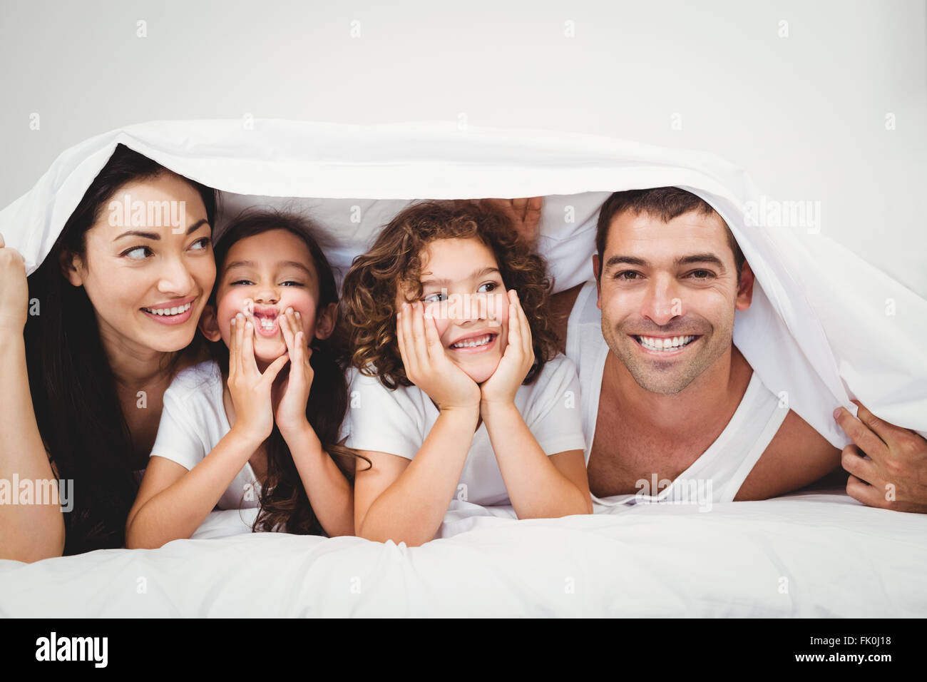 Mixed race family bed hi-res stock photography and images - Alamy